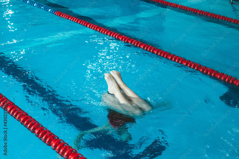 synchronized swimming athlete trains alone in the swimming pool ...