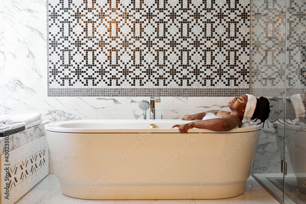 Relaxed African Woman Taking Bath With Foam With Pleasure Enjoying Spa