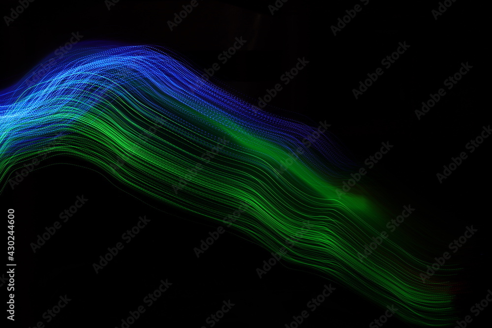 Blue-green light lines on a black background. . Color light painting ...