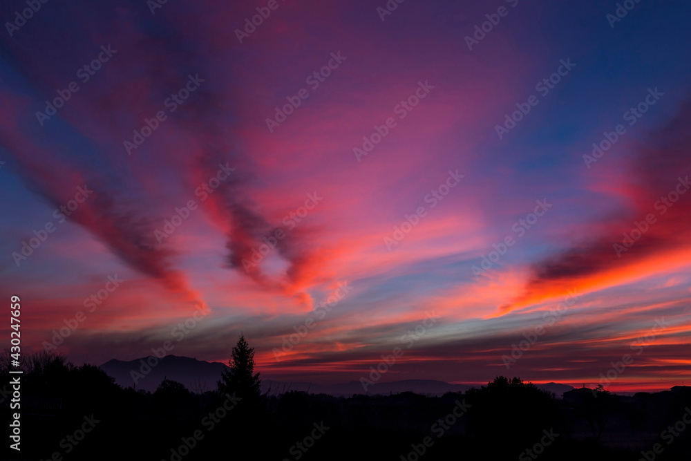 The intense colors of the dawn. The colored clouds cross the sky like ...