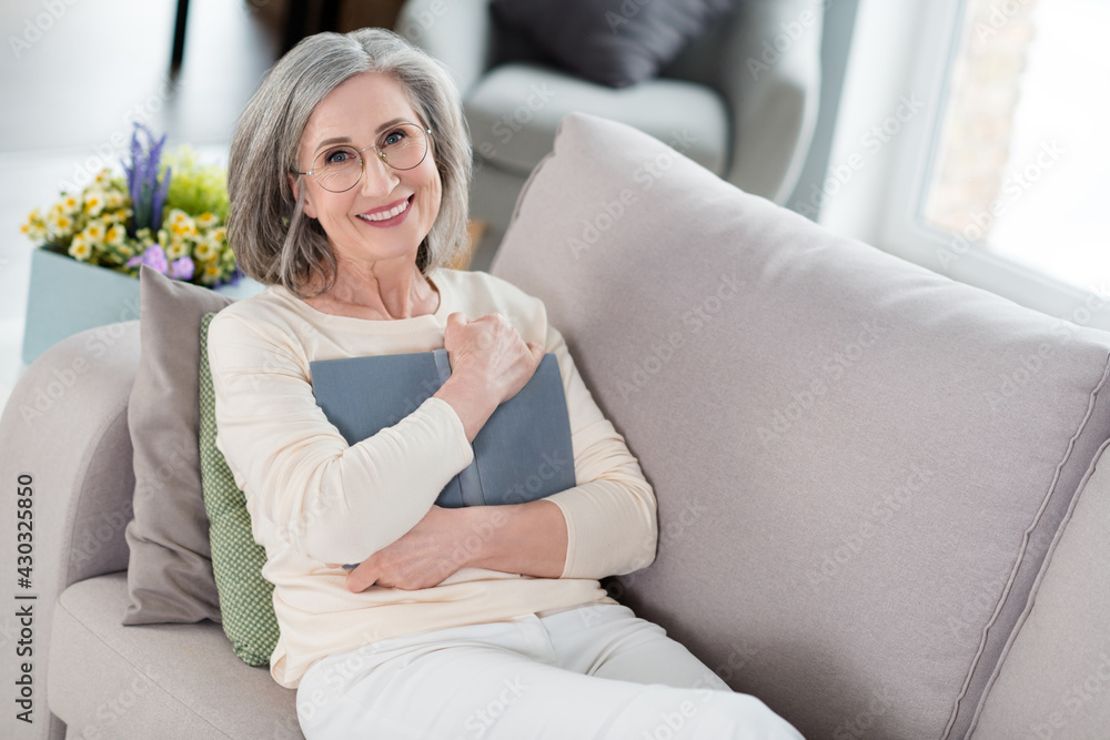 Portrait of attractive kind sweet cheerful woman lying on divan hugging ...