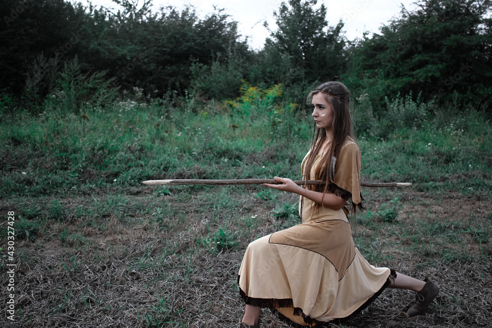 Apache tribe warrior striking with a spear, beautiful young girl in ...