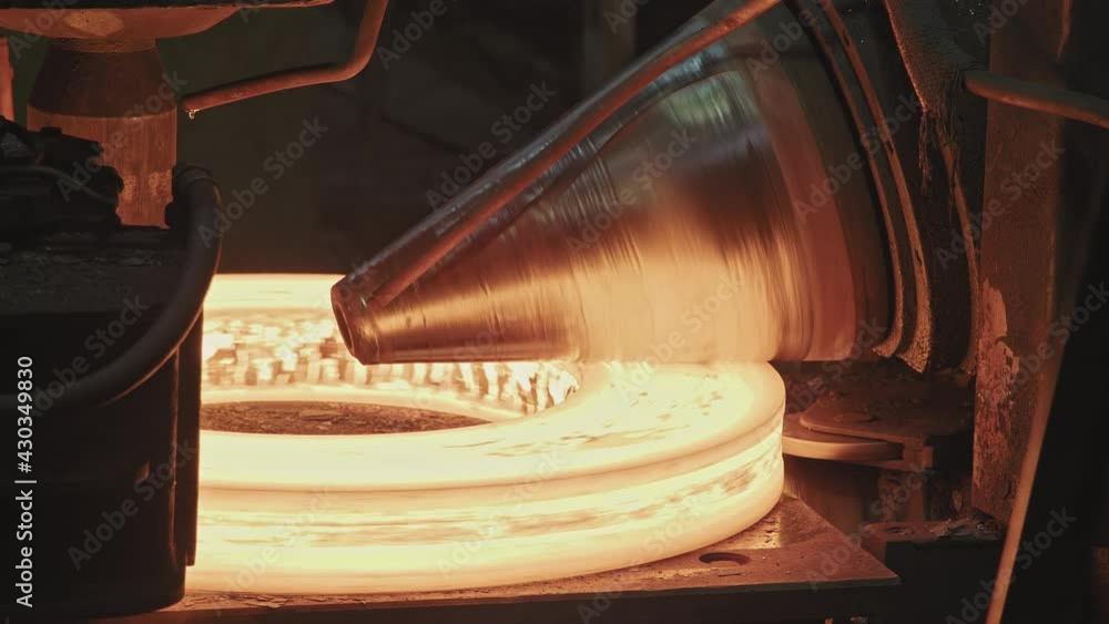 Close up of ring rolling process in forge shop. Professional ring ...