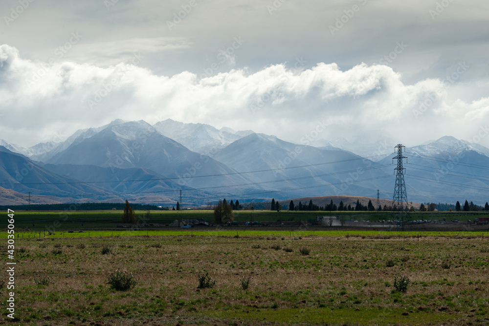 High voltage transmission towers and power lines with Ben Ohau Range in the background, Twizel ...