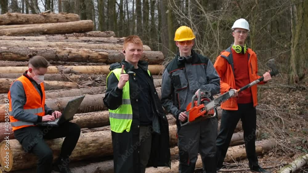 Logging workers team portrait. They pose with the focus on the camera ...