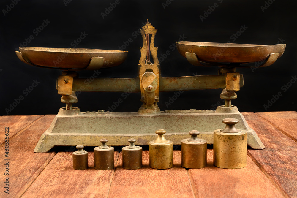Old vintage balance scales, cast iron with old and rusty weights on ...