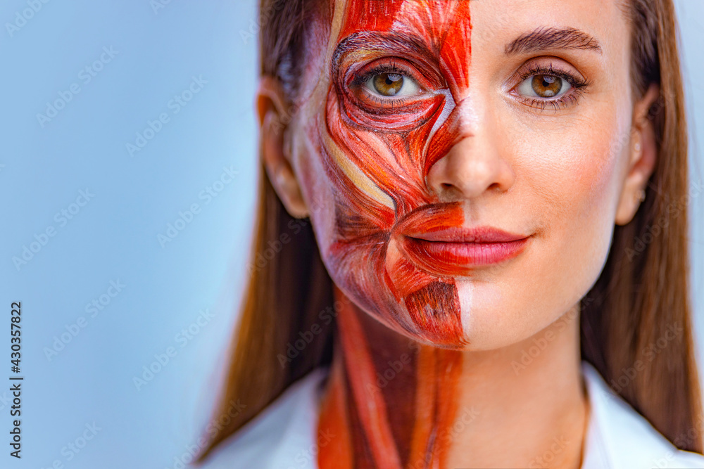 Cosmetology concept. Young woman with half of face with muscles ...