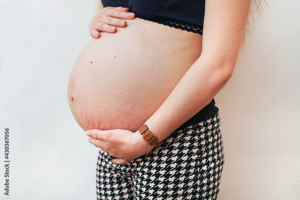 Big pregnant belly. Pregnant belly with stretch marks. Huge belly of a ...