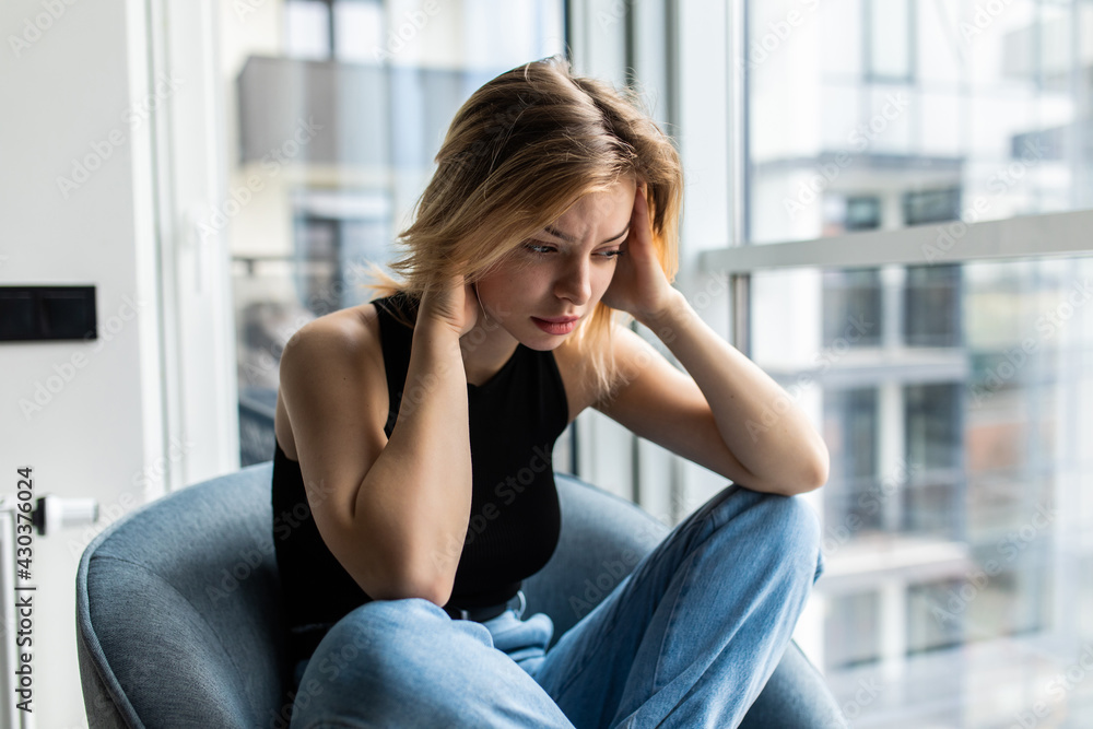 young sad woman sit beside window with vintage filter effect Stock ...