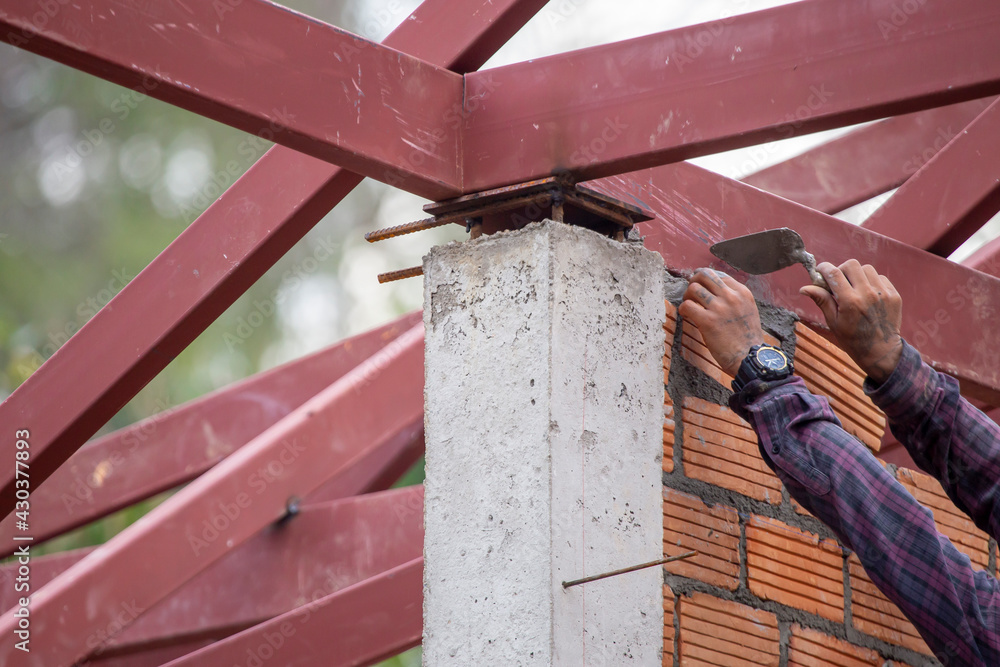 Red bricks and mason are building bricks to build the walls of the ...