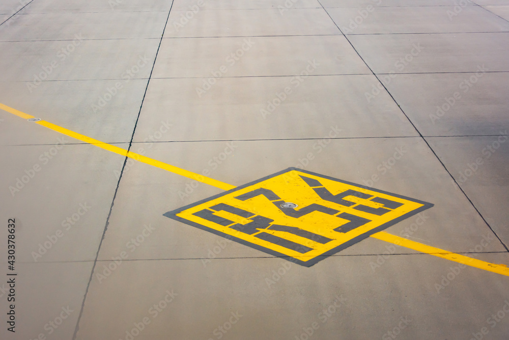 Airport yellow taxiway lines R36 markings on the apron on concrete ...