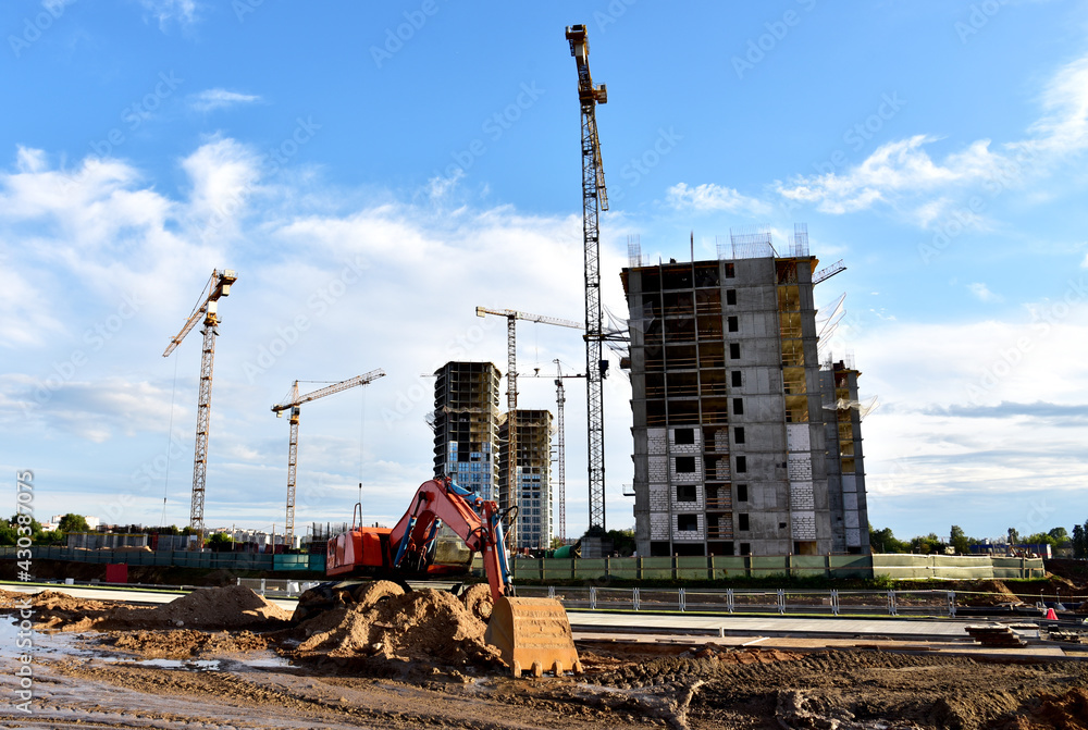 Excavator on earthmorks at construction site. Backhoe dig ground for ...