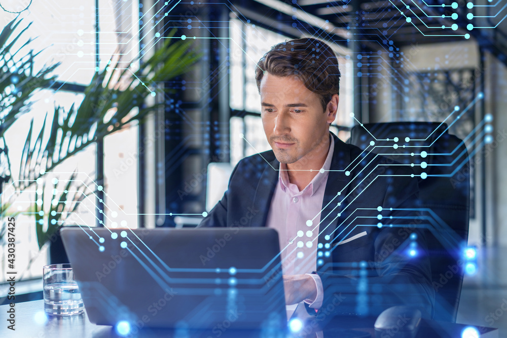 Handsome businessman in suit at workplace working with laptop to ...