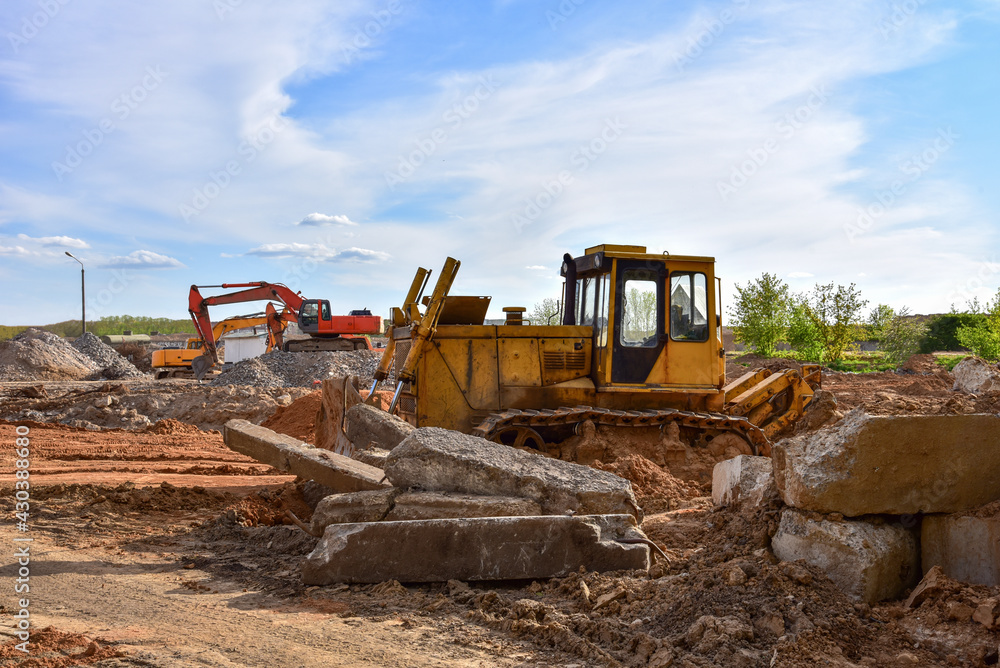 Bulldozer and excavator at landfill for work concrete demolition waste ...