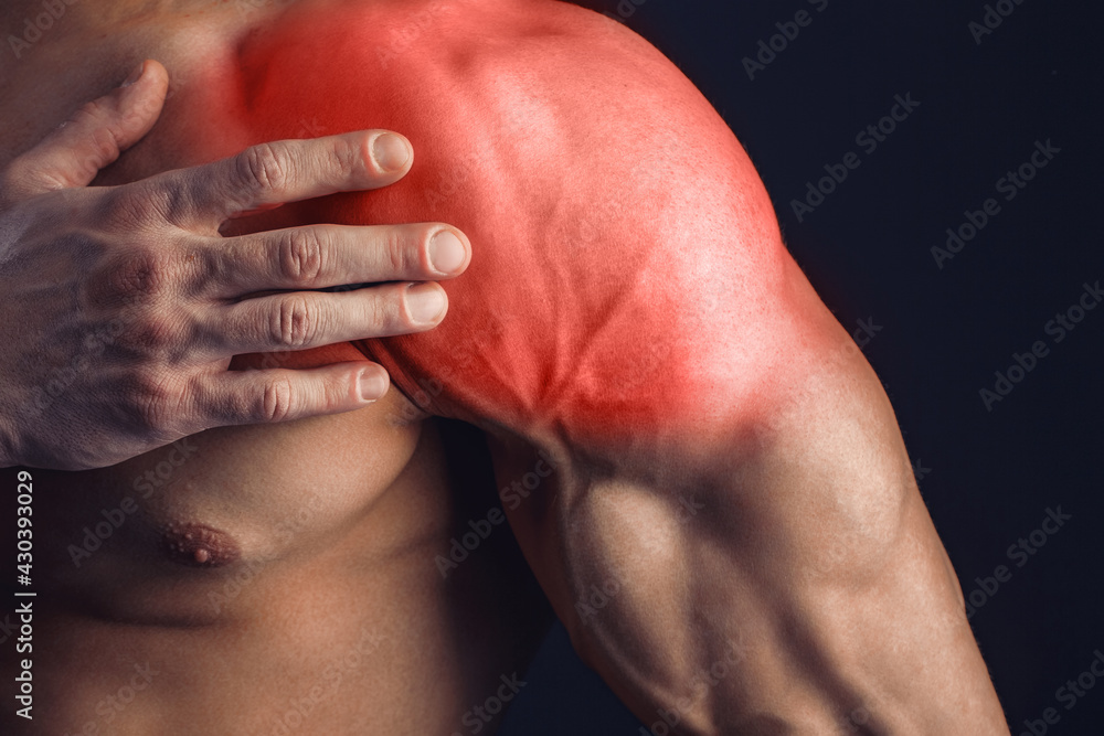 Bodybuilder suffering from shoulder pain on dark background. Stock ...