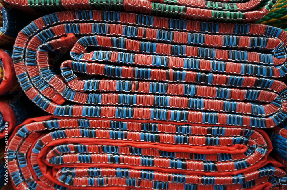 The overlapping texture of plastic fibers weaving in various colors ...
