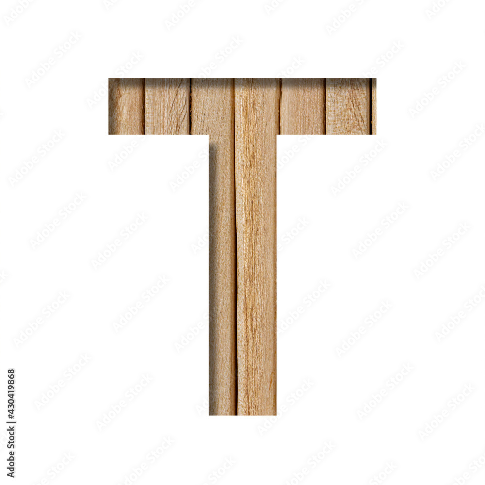 Font on light wood. Letter T is cut out of paper on a the background of ...