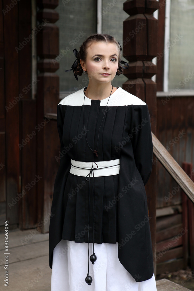 Amish fashion style. Fashion girl wearing stylish black and white dress ...