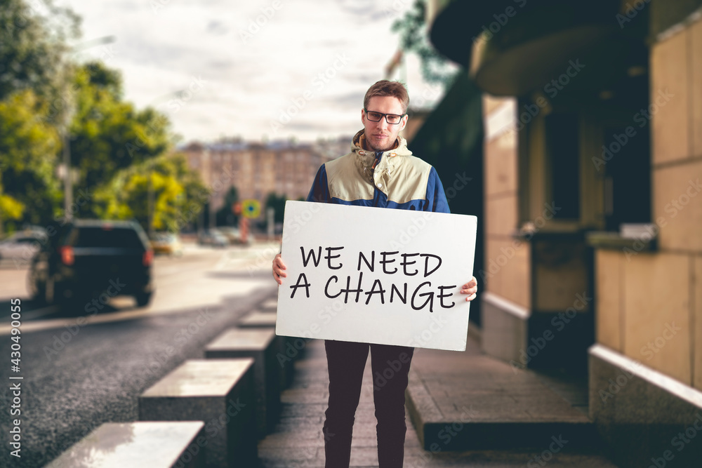 male young activist with cardboard, solo protest, political gesture ...
