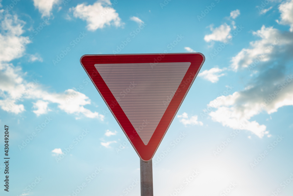 Road sign and blue sky with dark white clouds. Stock Photo | Adobe Stock