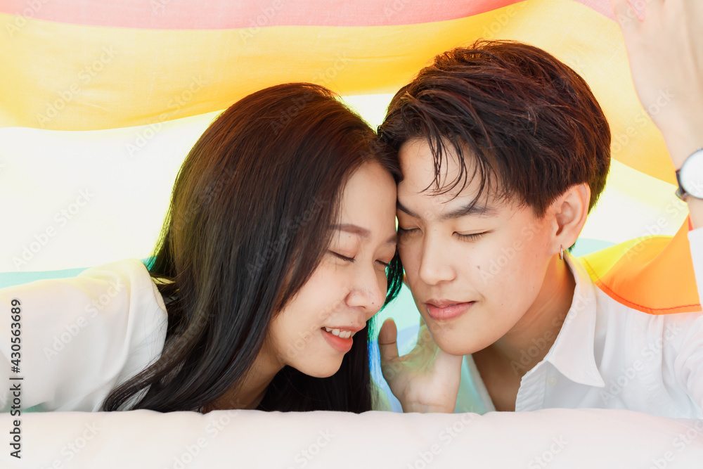 LGBTQ couple lovers, a handsome girl as a man or butch femme covered ...