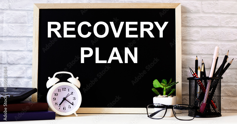 The words RECOVERY PLAN is written on the chalkboard next to the white ...