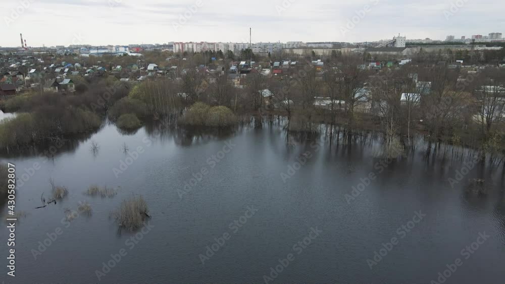 Spring flood, aerial view, flooded garden houses in the distance. A ...