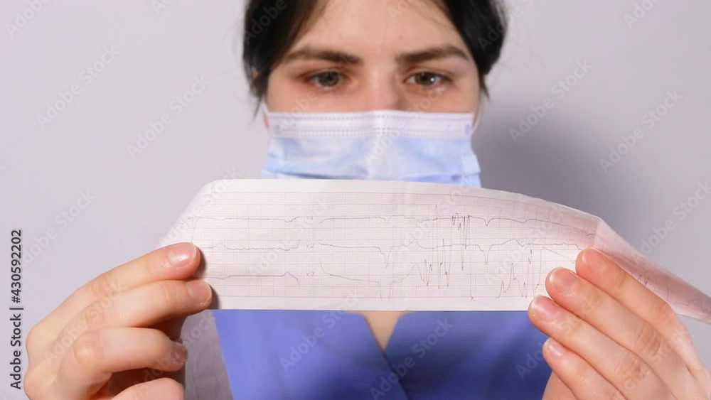 The cardiologist shows the film of an electrocardiogram of a patient ...