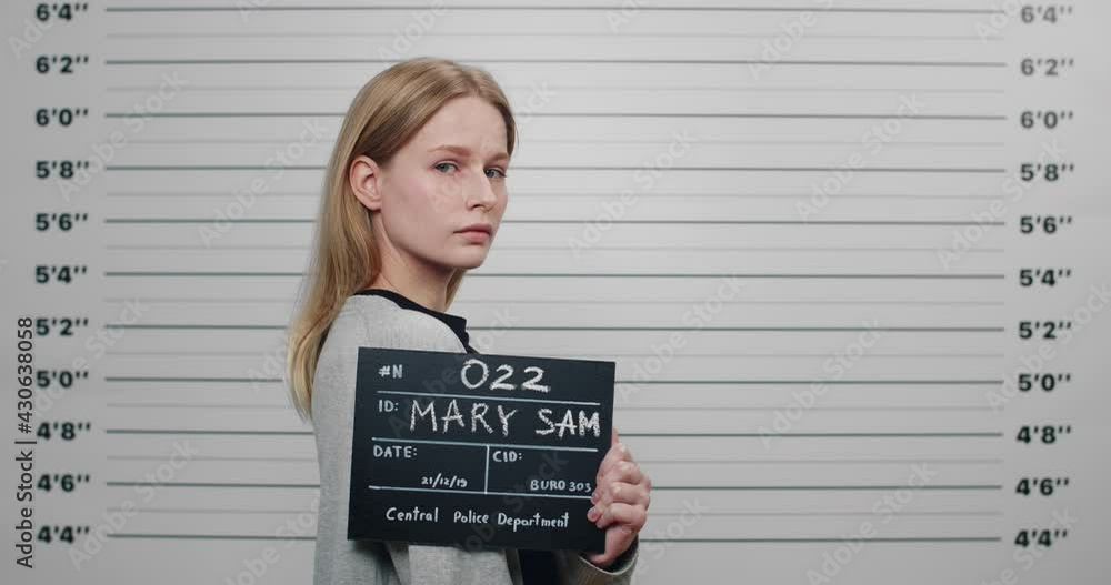 Side profile mugshot of young woman turning head and looking to camera ...