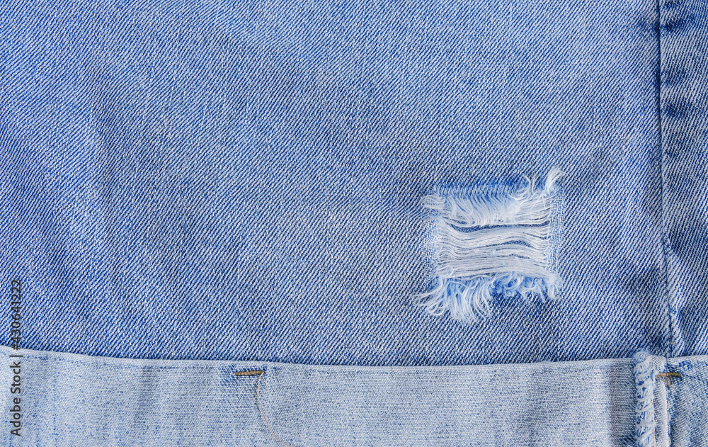 Tear of denim texture with a hole and threads showing. Stock Photo ...
