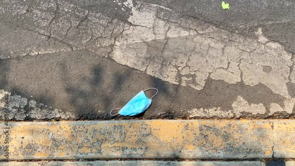 The protective medical mask fell to the ground in the city. Covid-19 ...