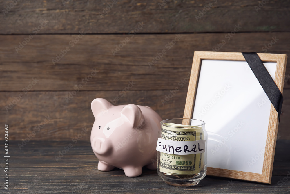 Piggy bank with money and photo frame on dark wooden background Stock ...