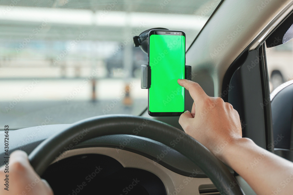 Mock up of man using mobile smart phone inside a car. Driver hand ...