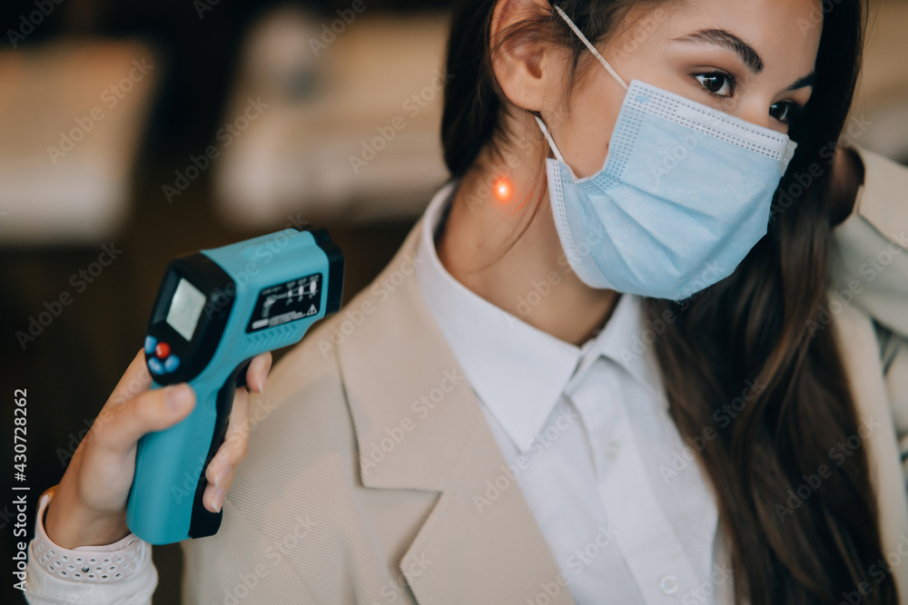 Measuring body temperature with contactless body thermometer Stock ...