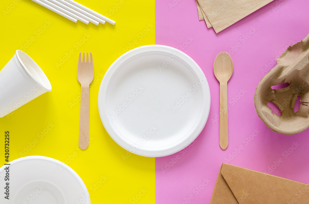 Disposable, compostable and recycle packgages on yellow and pink ...