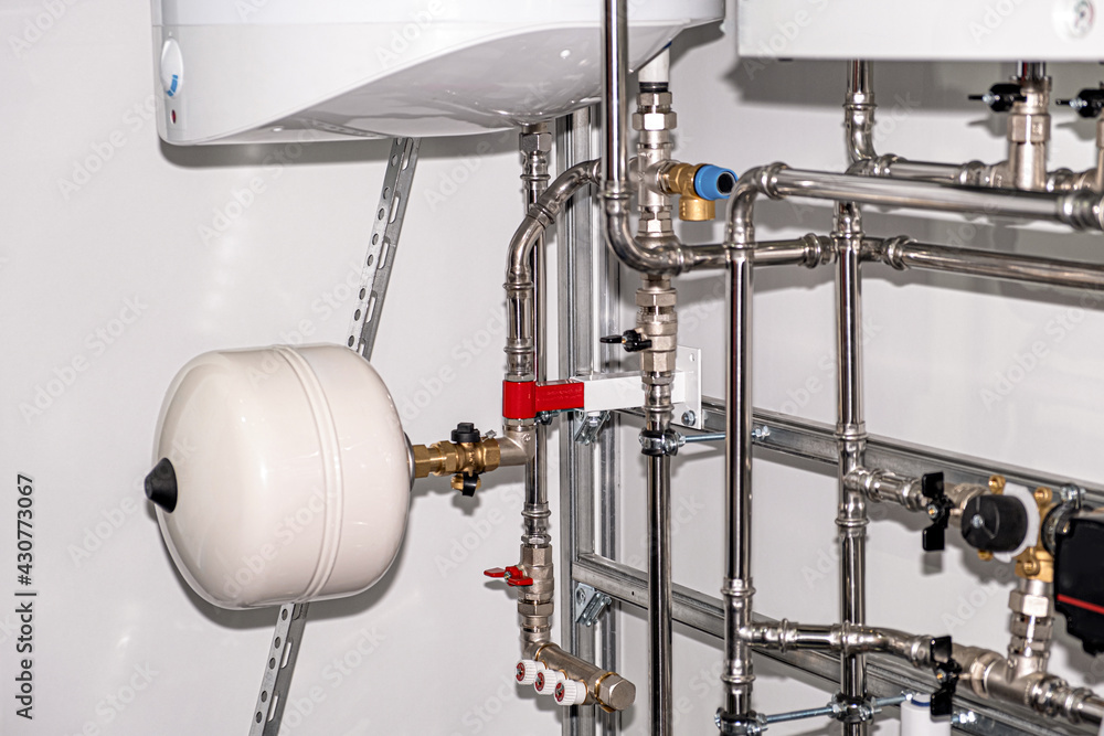 Plumbing services. Stainless steel piping of the heating system in the ...
