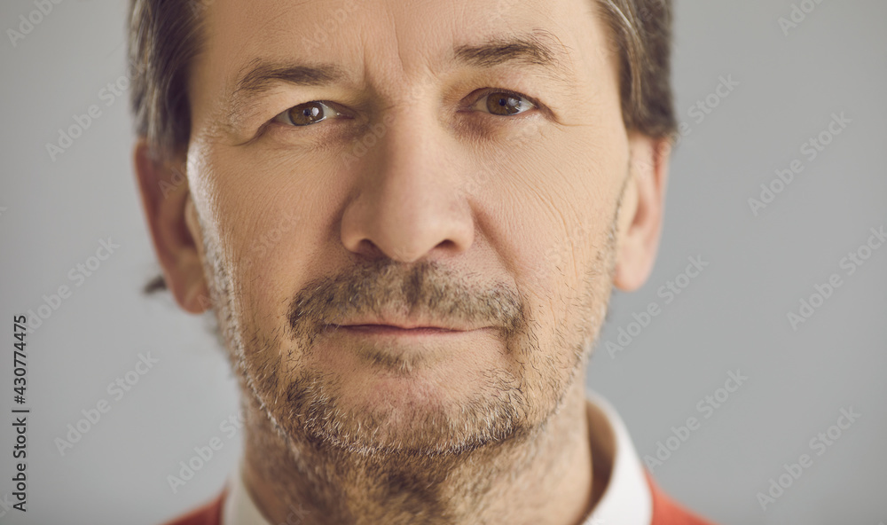 Extreme closeup portrait of senior European man with serious face ...