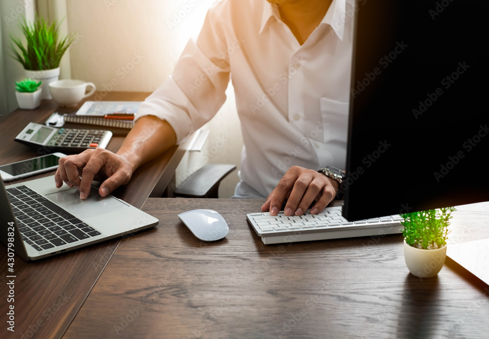 man hands using keyboard of laptop computer on office desk. Businessman ...