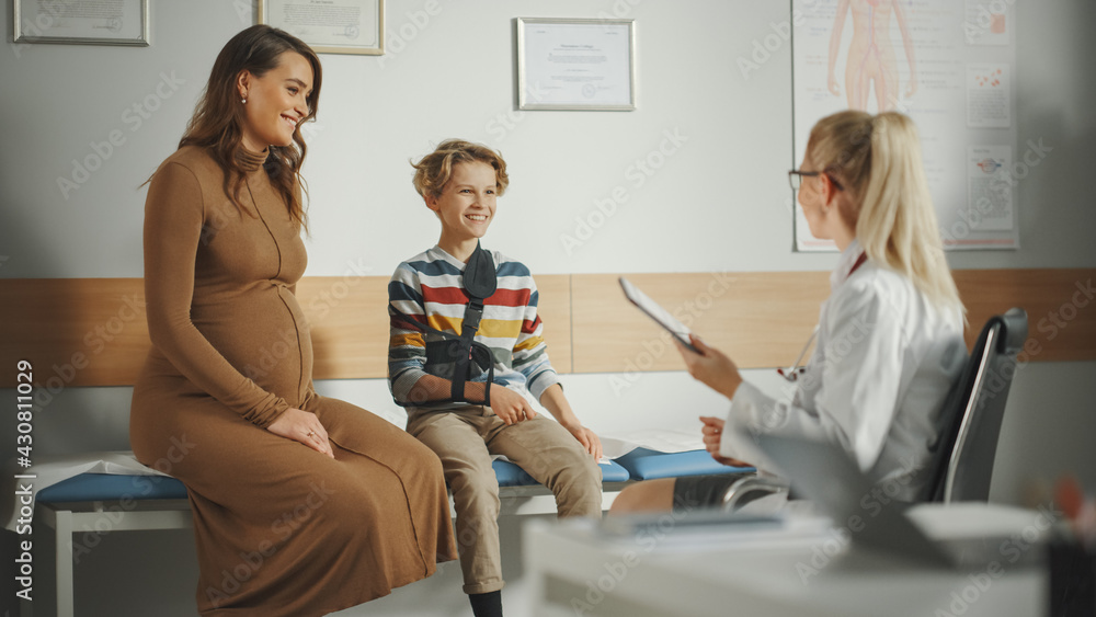 Female Family Doctor Talking with Young Pregnant Woman and Her Teenage ...