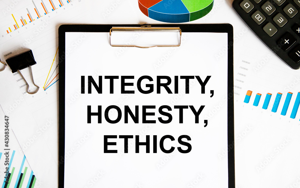 ON the letter tablet text INTEGRITY, HONESTY, ETHICS, near charts and ...