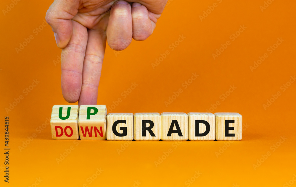 Upgrade or downgrade symbol. Businessman turns wooden cubes, changes ...