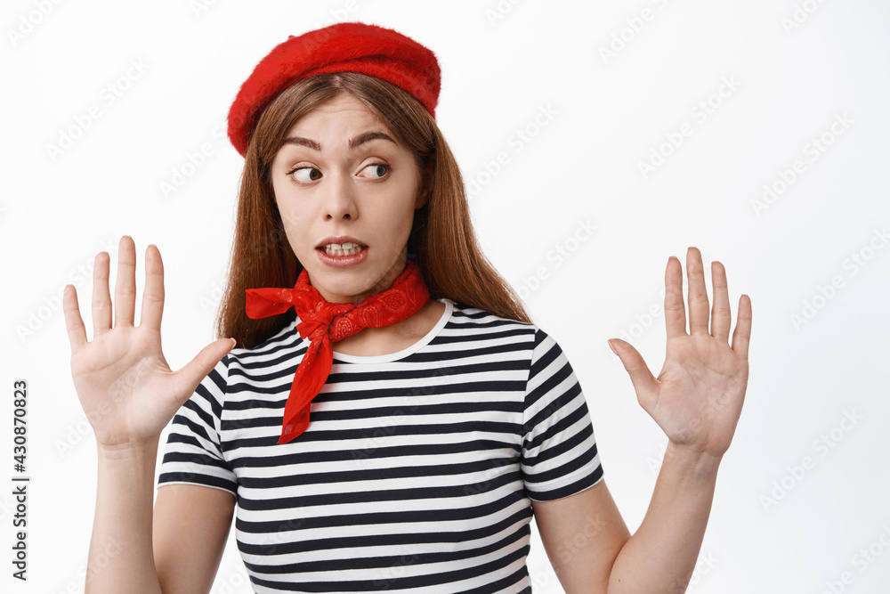 Funny young woman perform pantomime, mime tilting away, raising hands ...