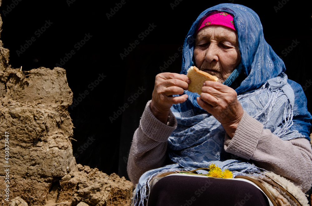 Bread in old hands. Wrinkled hands with a piece of bread. Need food ...