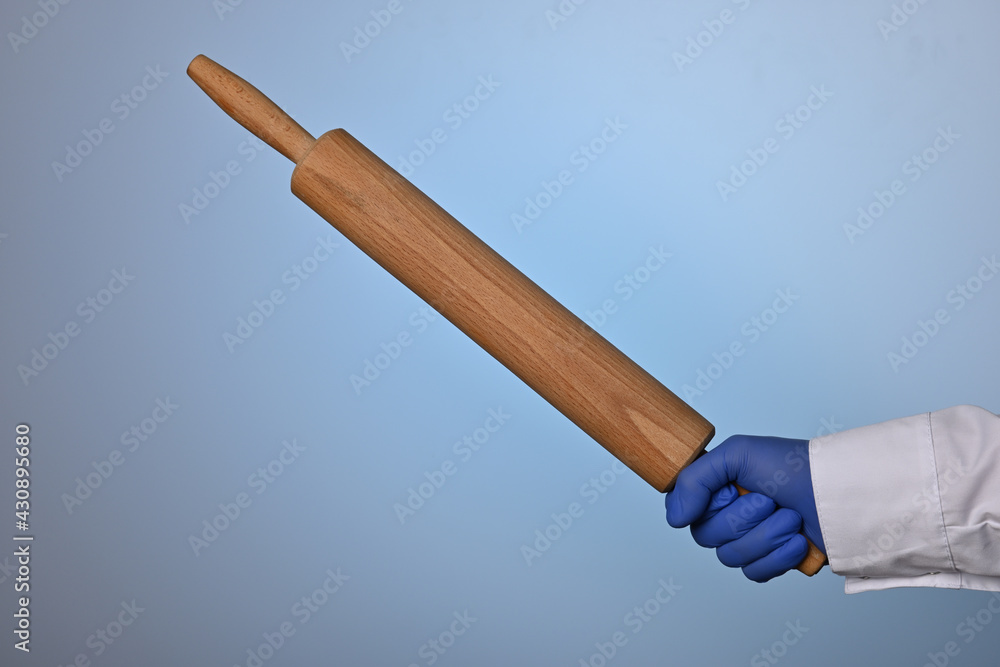 Doctor hand shows rolling pin. Medic hand holds wood cylinder for ...