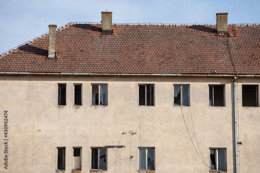 Facade of a residential building, abandoned, in decay, with plenty of ...