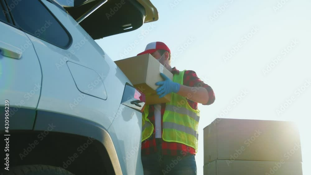 Parcel delivery concept. Male courier driver wearing protection mask ...