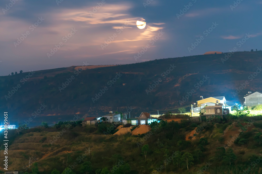 Night scene in the valley bright houses with colorful lights makes the ...