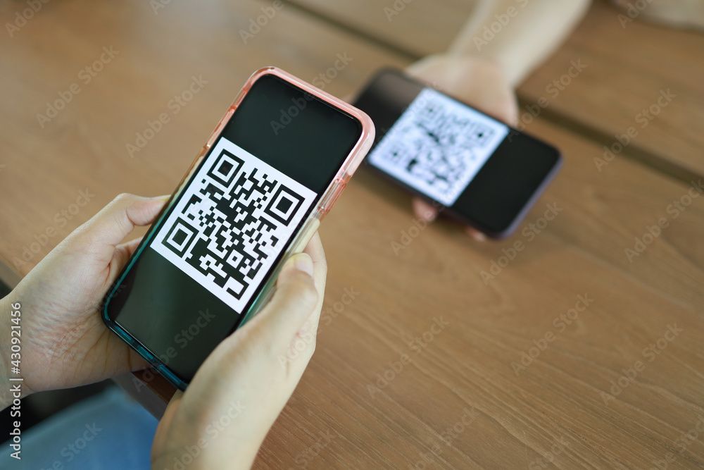 Qr code payment. Woman scanning QR code online shopping cashless ...