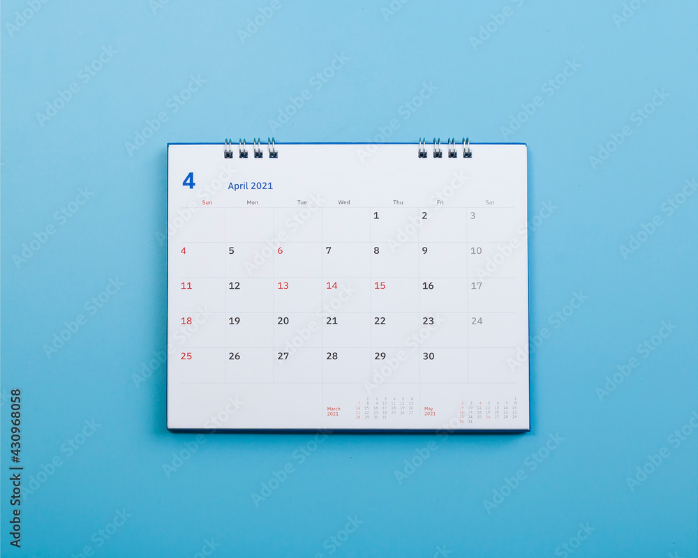 White calendar laying on blue background planning concept. Stock Photo ...