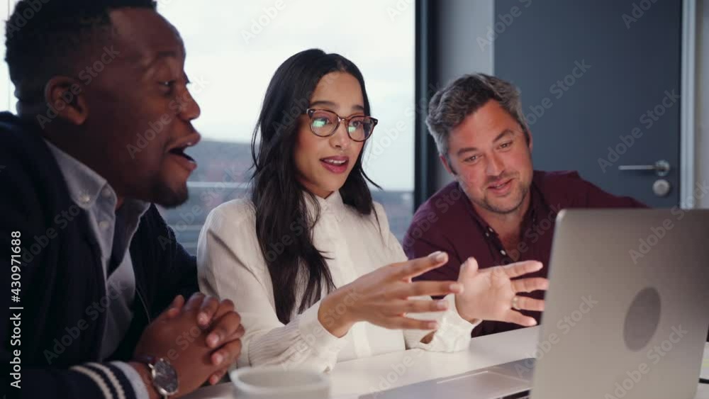 Diverse group of colleagues working together on presentation creating ...